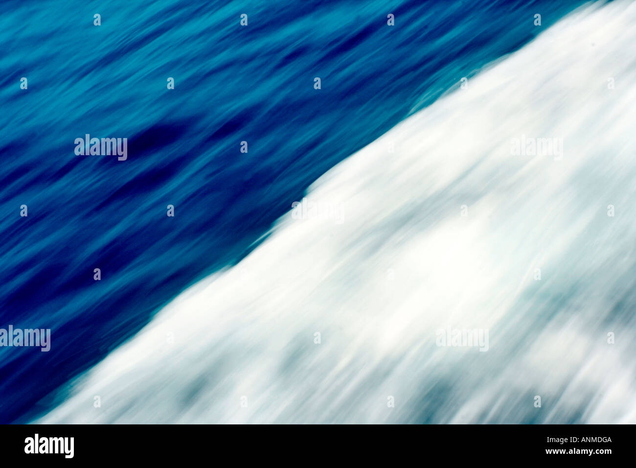 White froth caused by the passage of a boat in the blue waters of ...