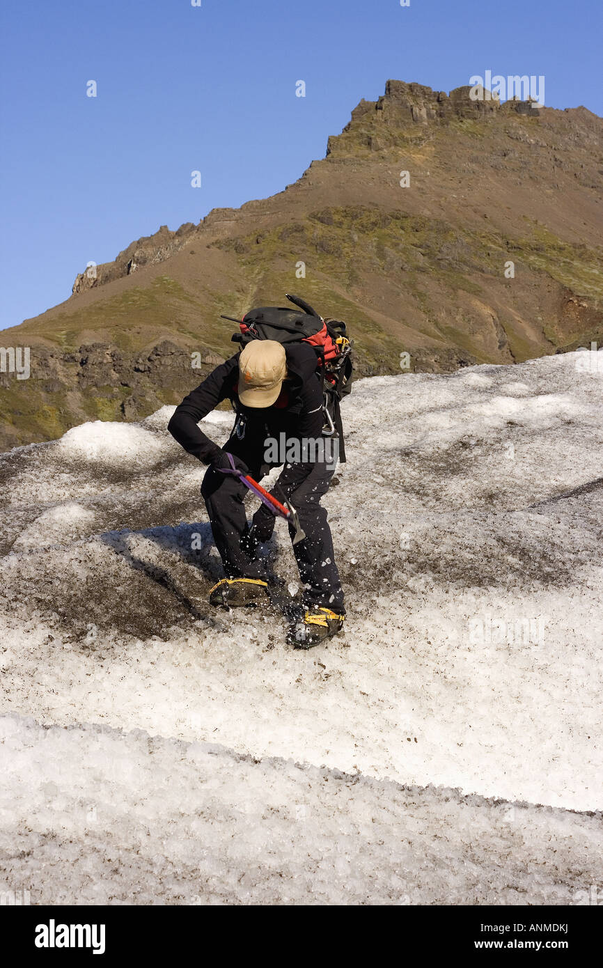 Cutting steps in steep ice slope in Vatnajokull glacier Iceland Stock ...