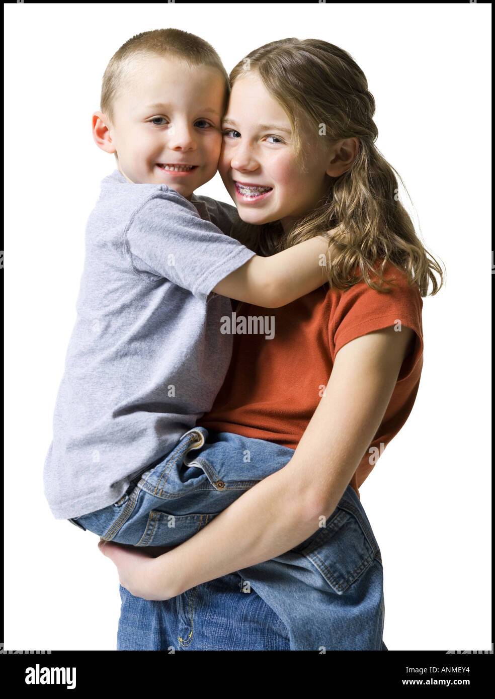 Portrait of a sister carrying her brother and smiling Stock Photo - Alamy