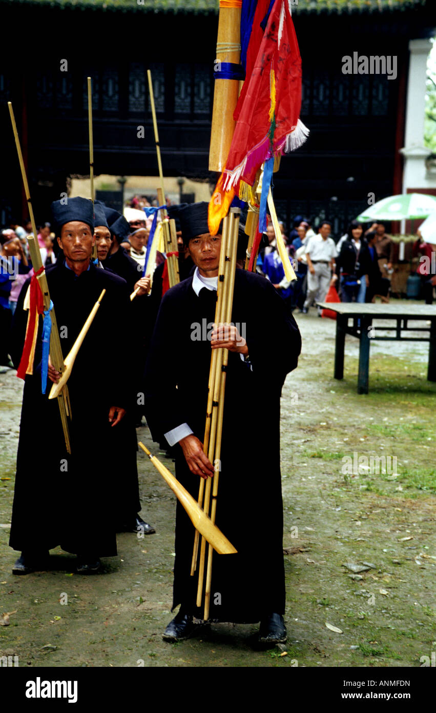 Miao men hold colorful flags during a big festival in Guizhou China ...