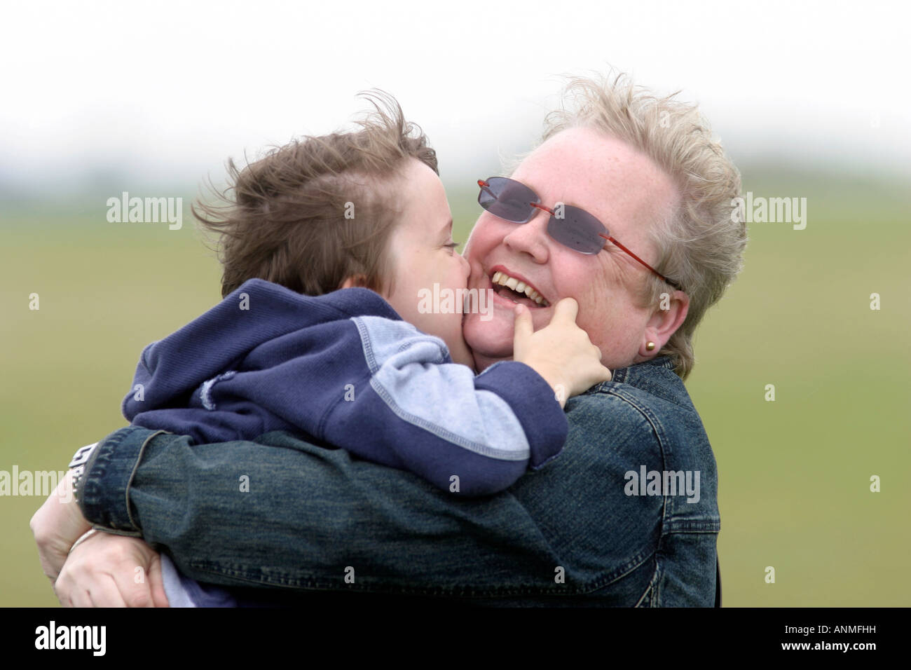 Mother and child caught in mid hug. Donnington Aeropark, Leicestershire ...