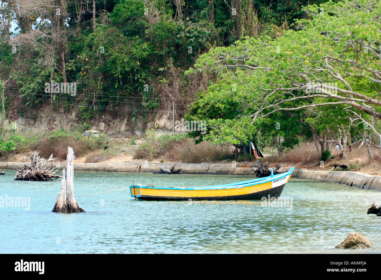 A boat inside a fenced lake encircled by a road at Jolly buoy Andaman ...