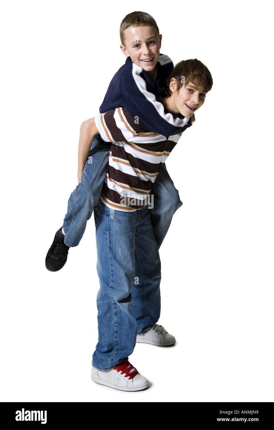 Portrait of a boy riding piggyback on another boy Stock Photo - Alamy