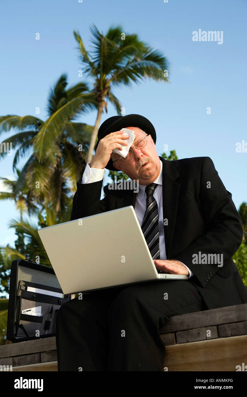 Maldives sweating businessman in bowler hat and business suit working ...