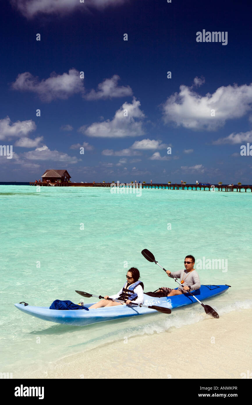Maldives South Male Atoll Olhuveli Resort couple in sea kayak in ...