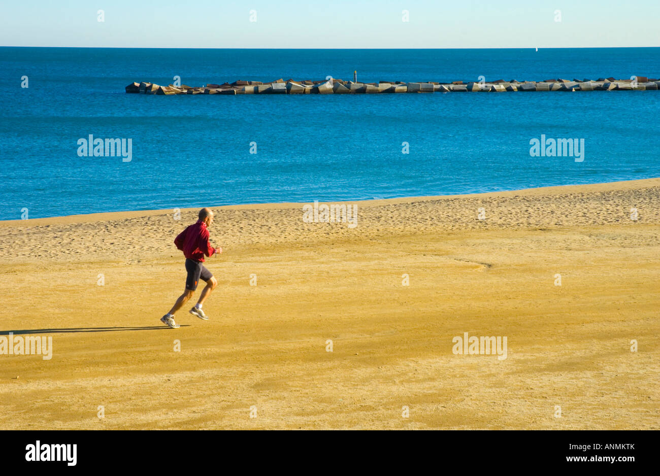 Man running at Barceloneta beach in Barcelona Spain EU Stock Photo - Alamy