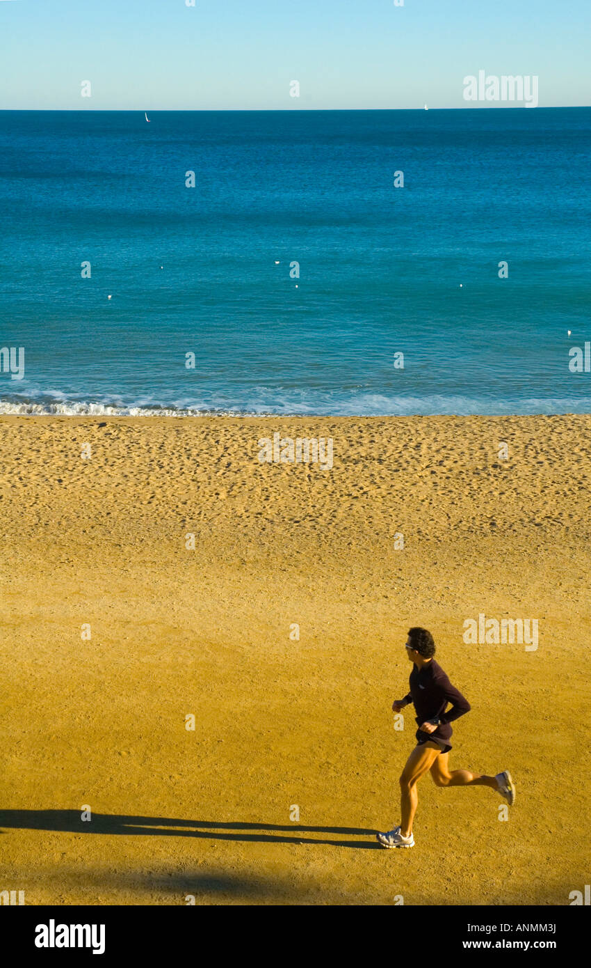 Man running at Barceloneta beach in Barcelona Spain EU Stock Photo - Alamy