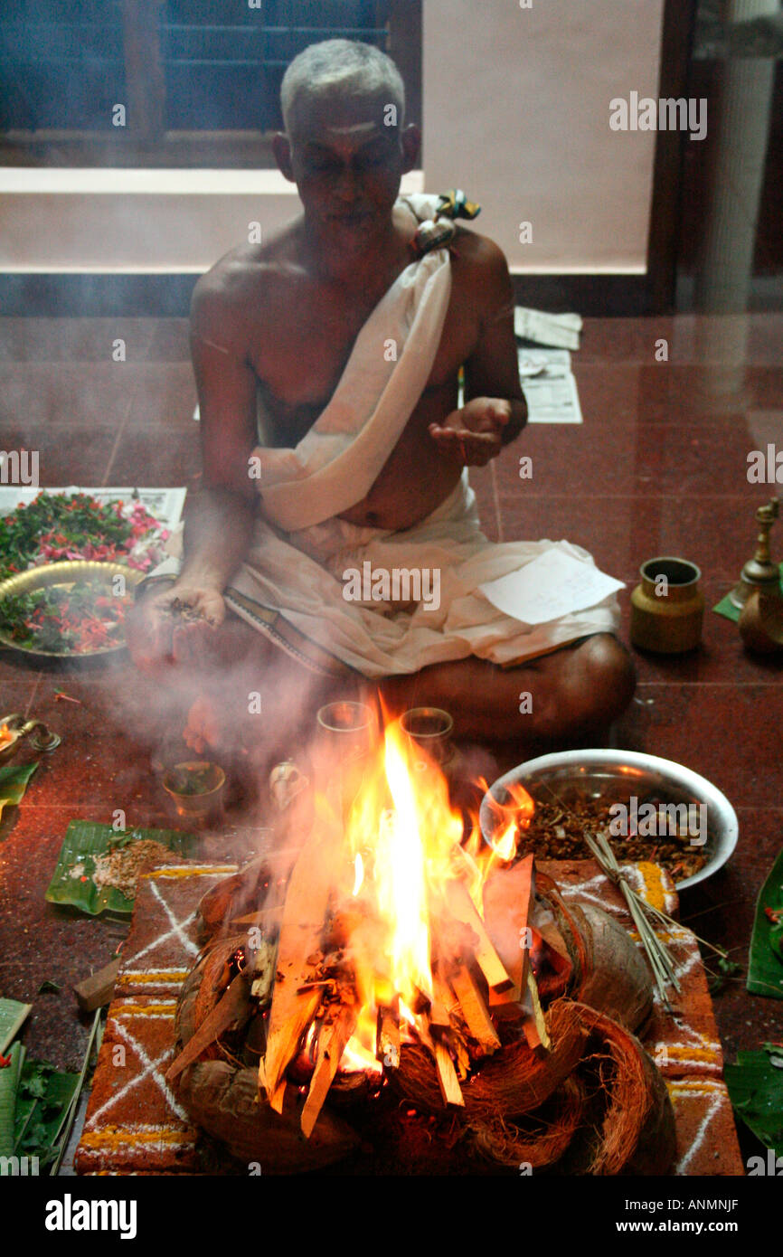 Priest performing religious rites before sacrificial fire in a new ...