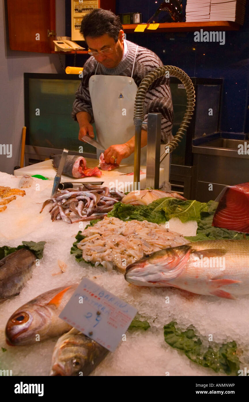 A man cutting fish at Santa Caterina market in Barcelona Catalonia ...