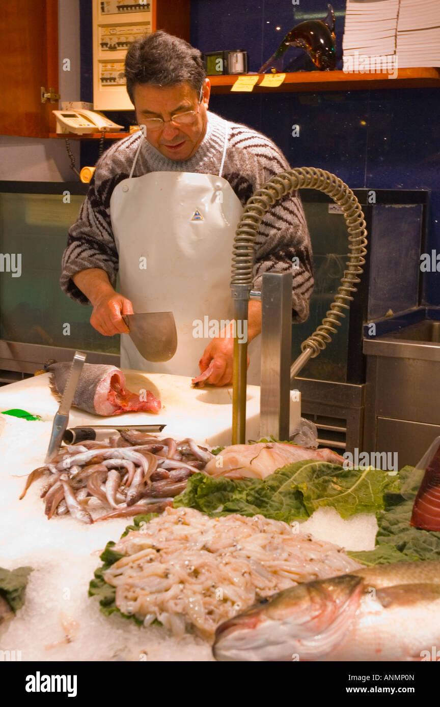 A man cutting fish at Santa Caterina market in Barcelona Catalonia ...