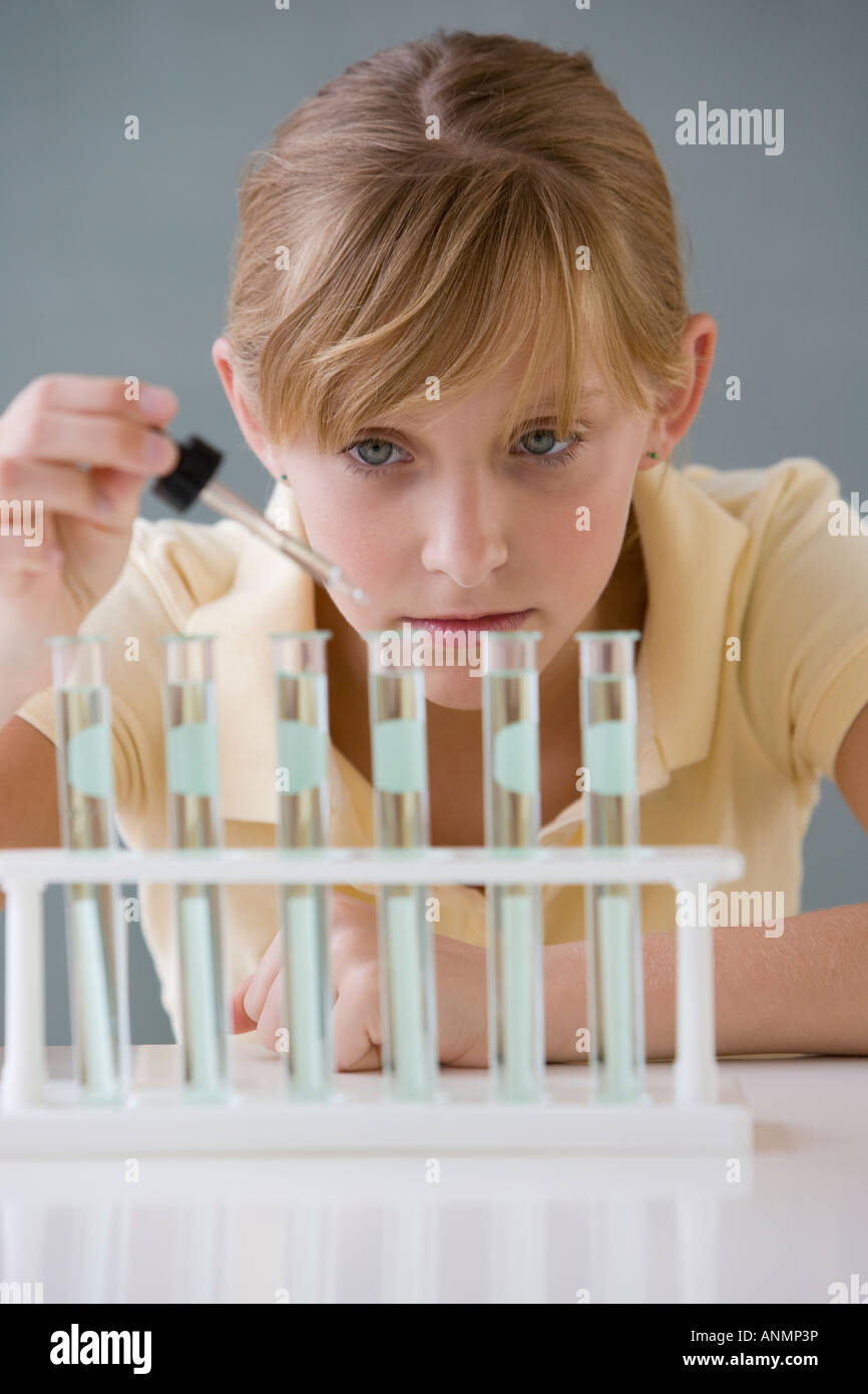 Teenaged girl dropping liquid in vials Stock Photo - Alamy