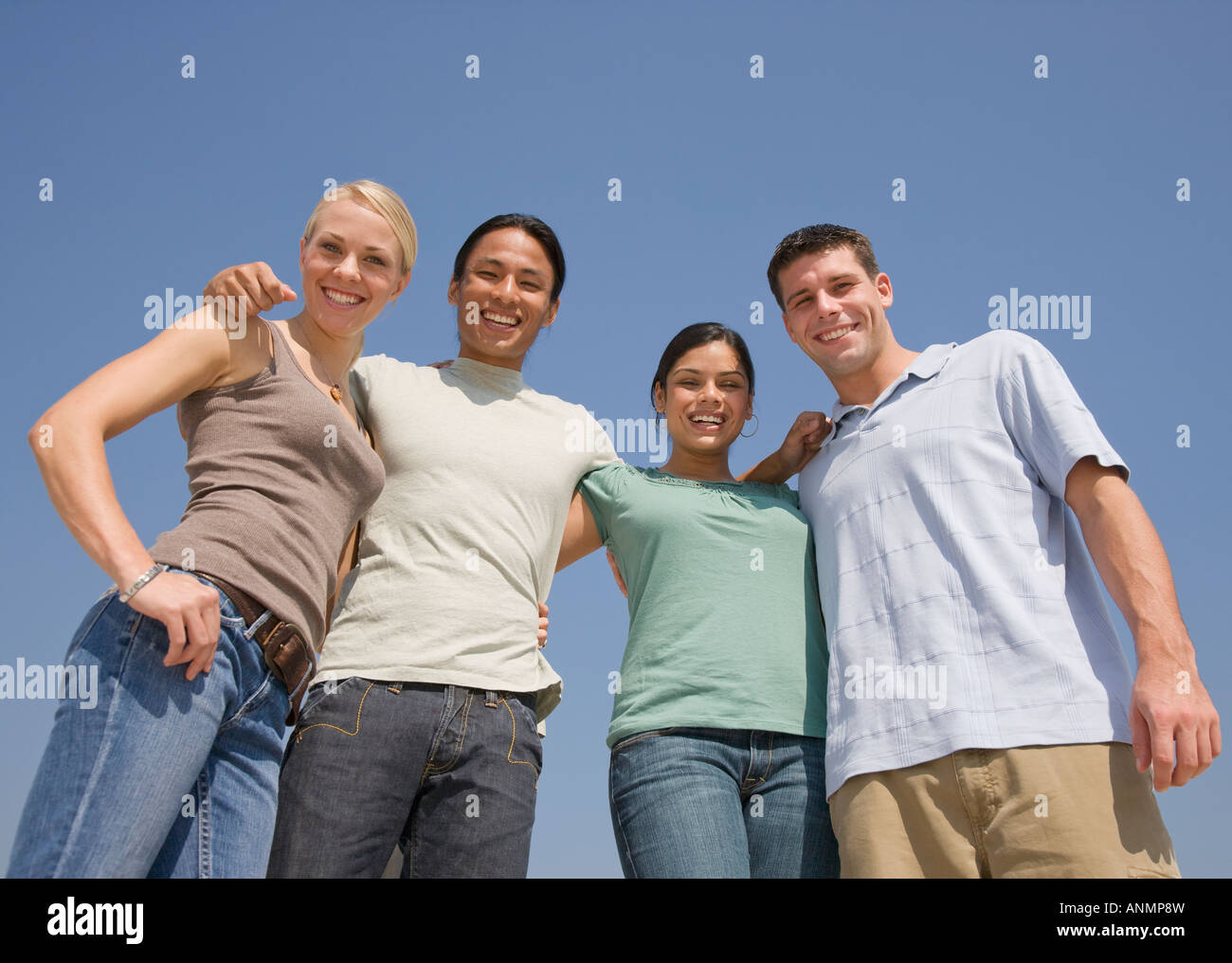 Multi-ethnic friends arm in arm Stock Photo - Alamy