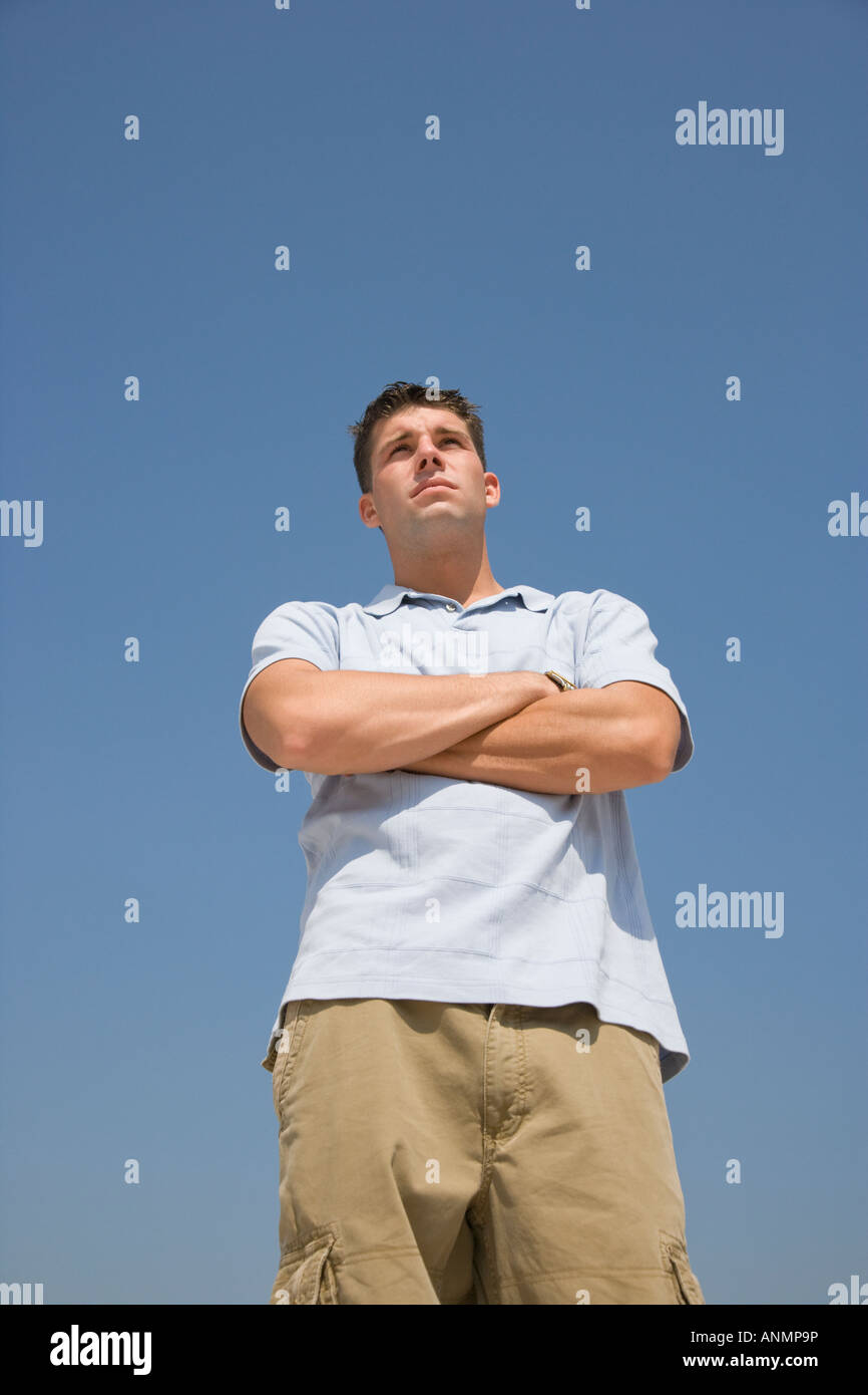 Young man with arms crossed Stock Photo - Alamy