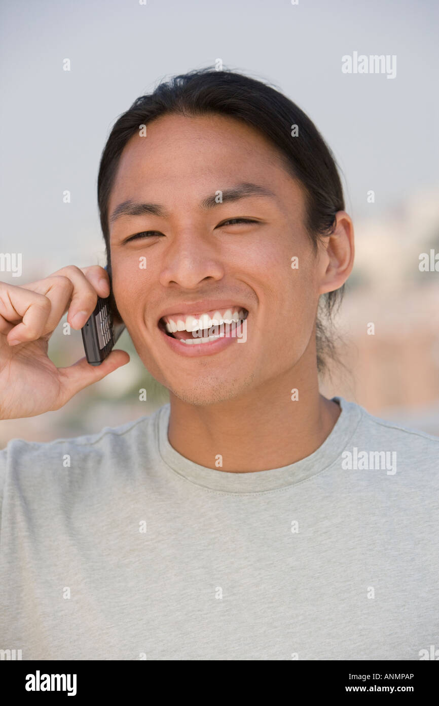 Asian man talking on cell phone Stock Photo - Alamy