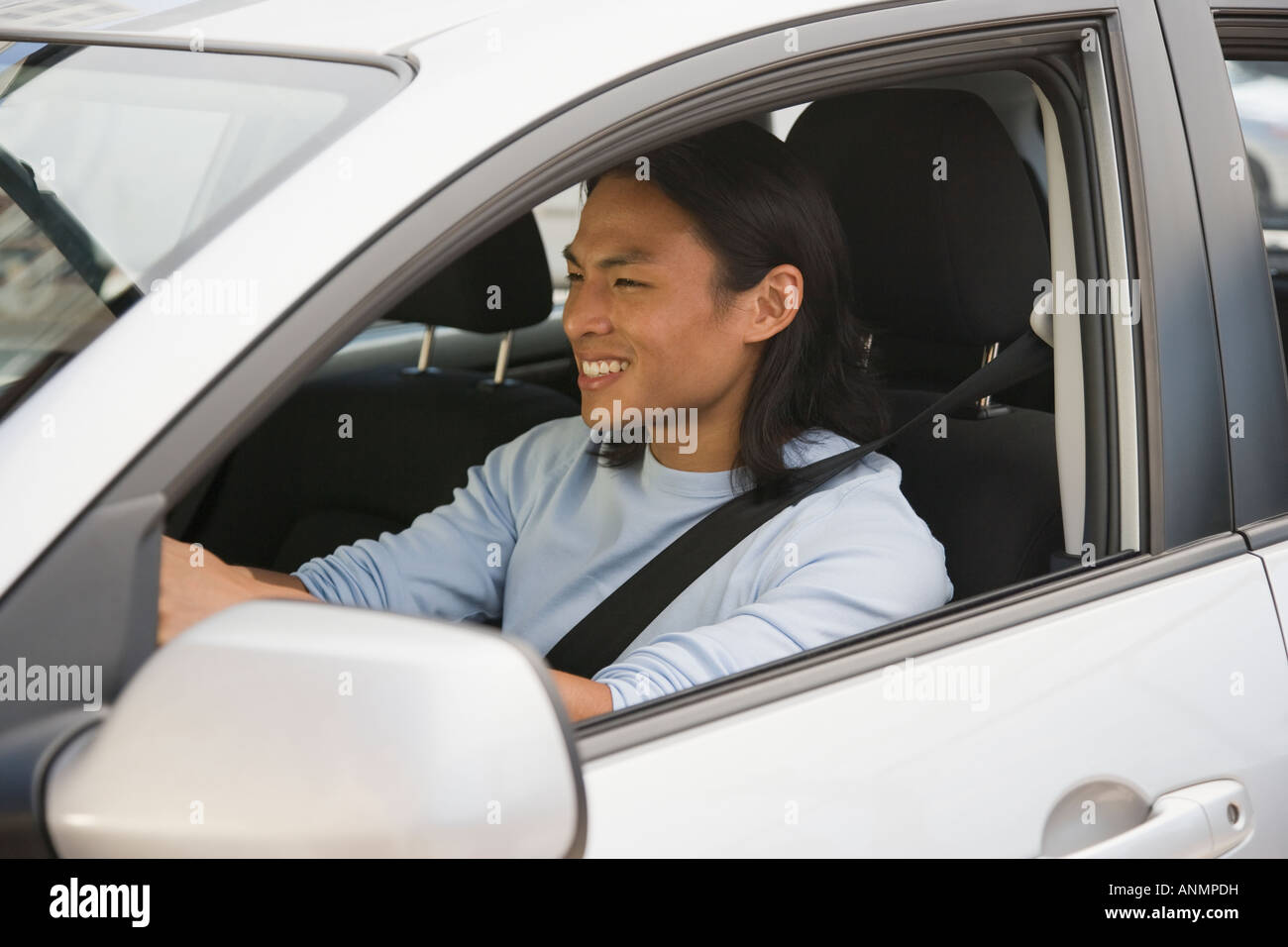 Asian man driving in car Stock Photo - Alamy