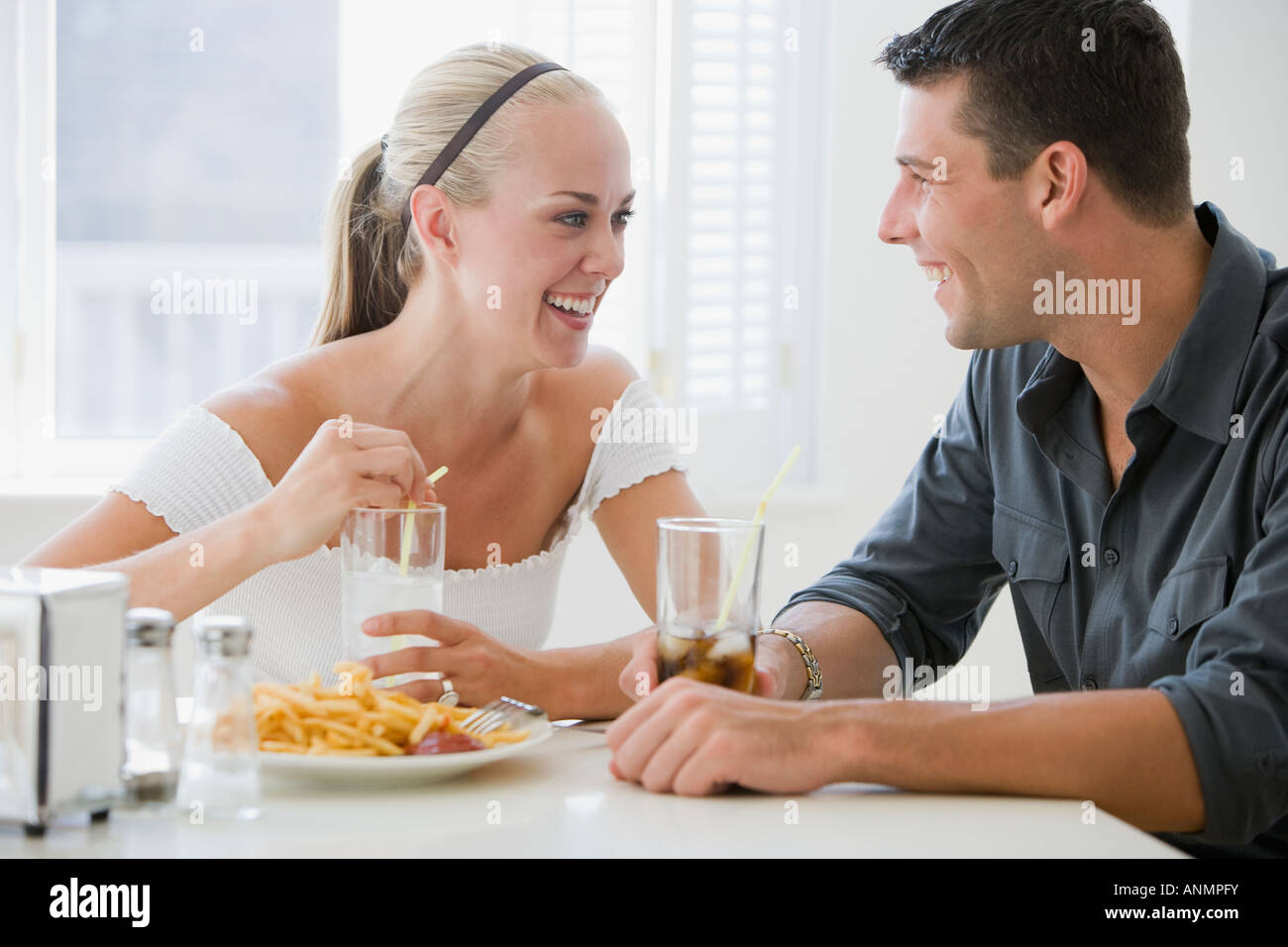 Couple eating at diner Stock Photo - Alamy