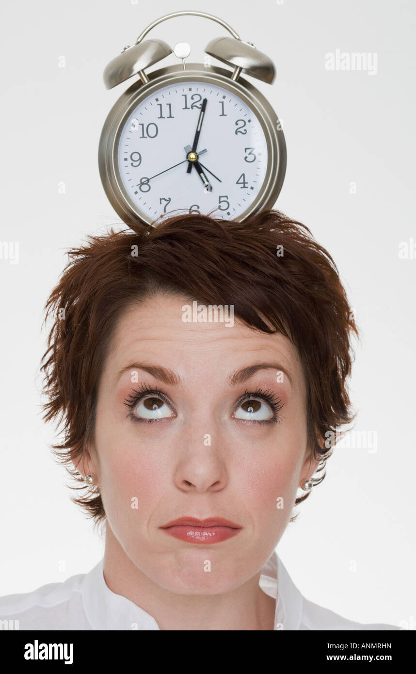 Woman with alarm clock on head Stock Photo - Alamy