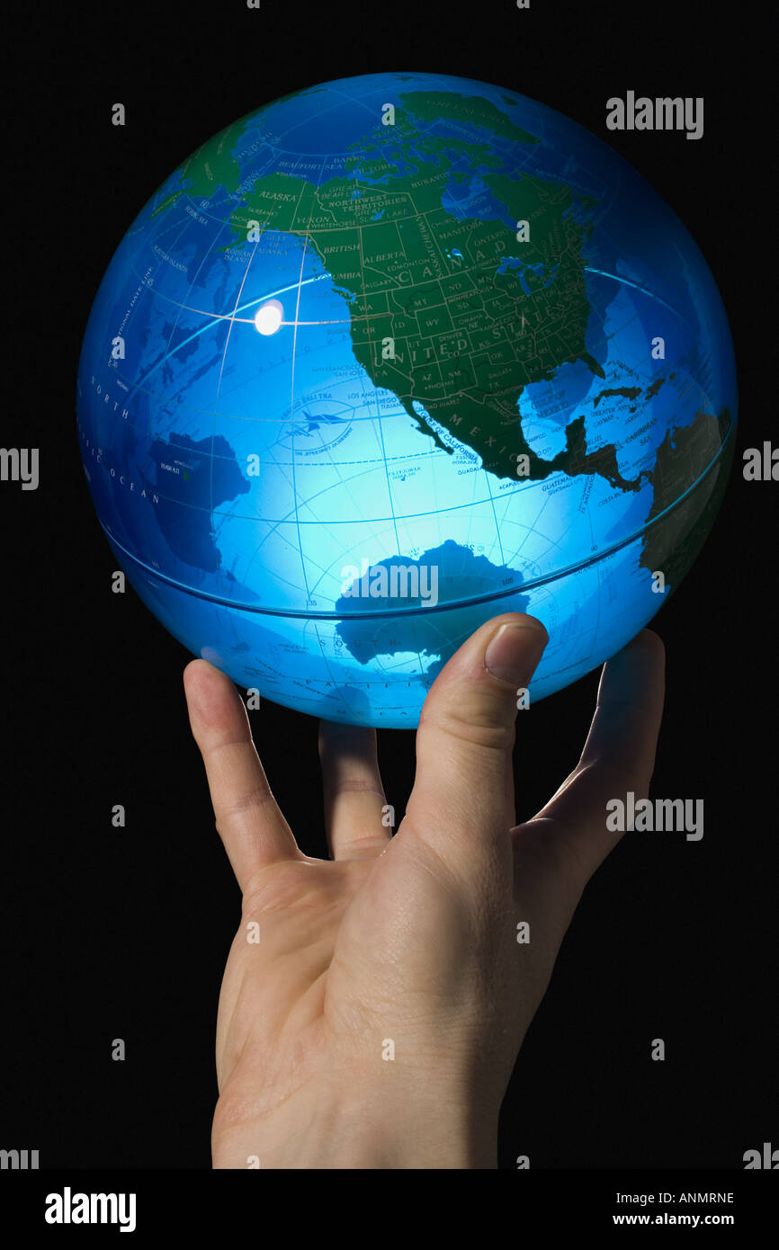 Hand holding earth globe on fingertips Stock Photo - Alamy