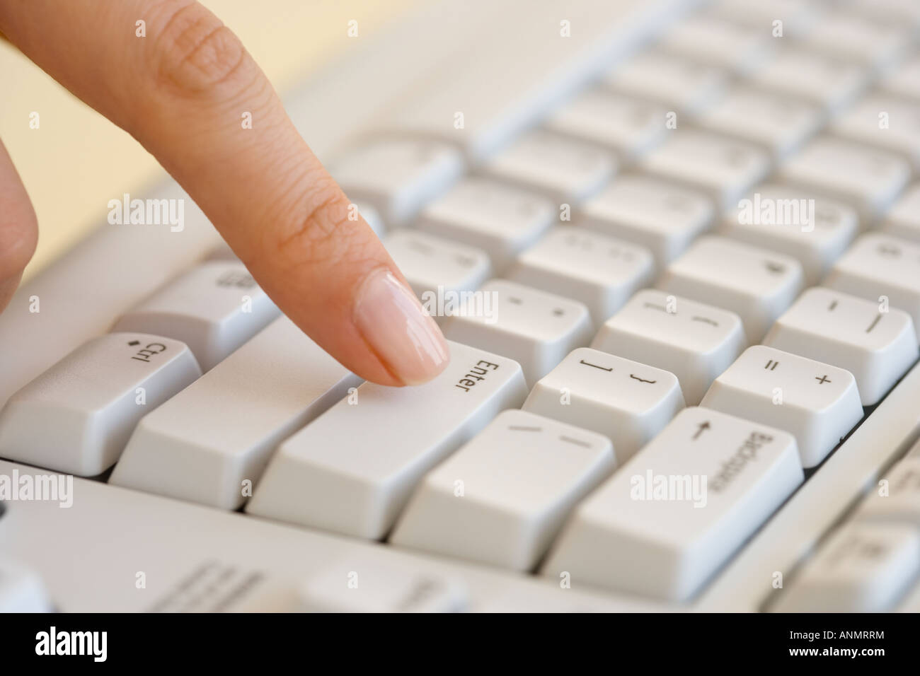 Woman pressing Enter key on computer keyboard Stock Photo - Alamy