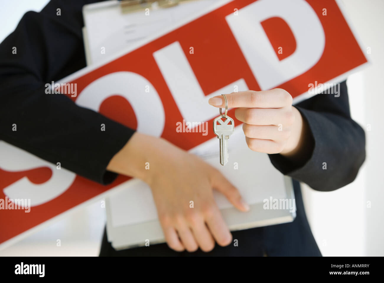 Real Estate agent holding clipboard and Sold sign Stock Photo - Alamy