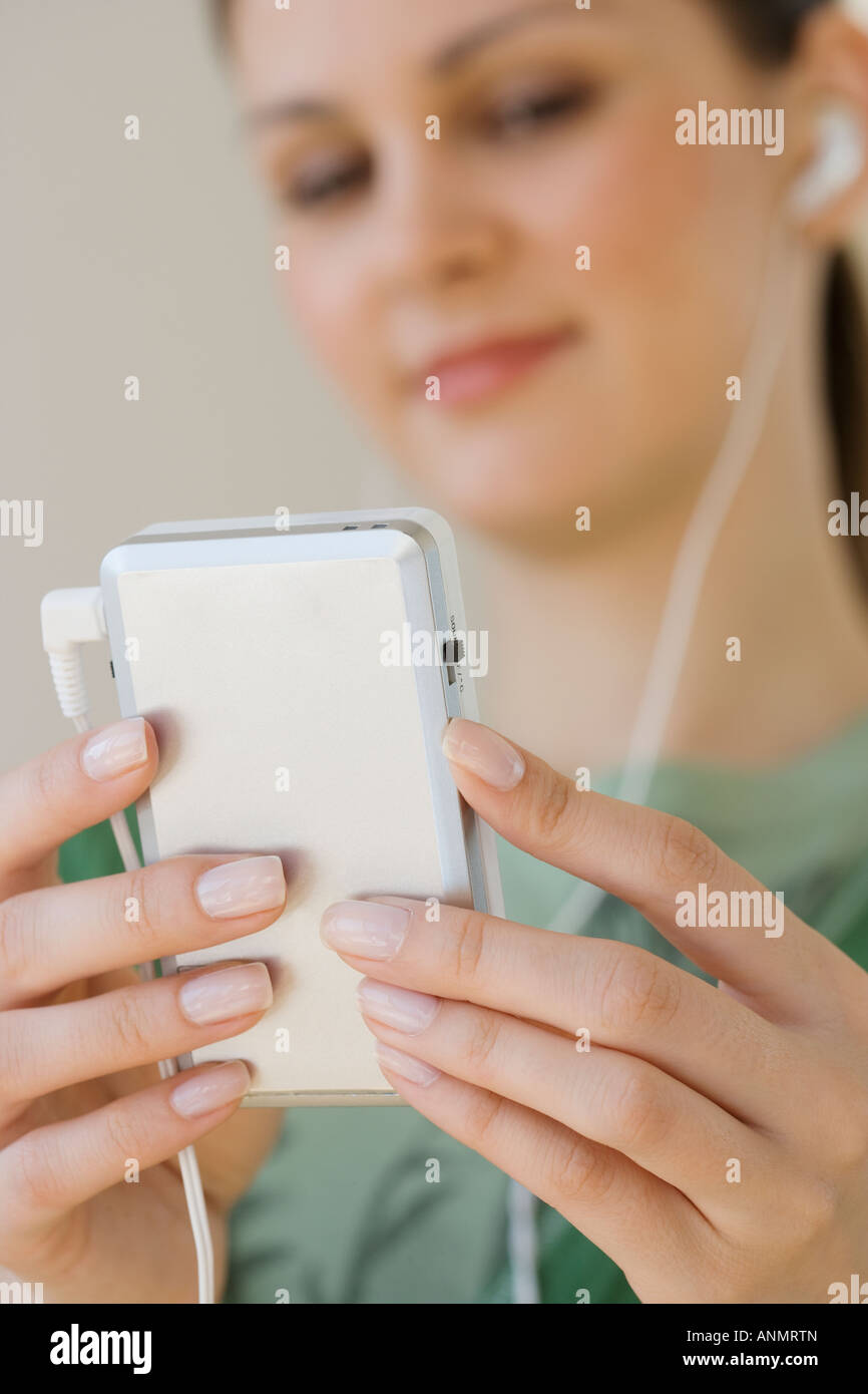 Woman listening to mp3 player Stock Photo - Alamy