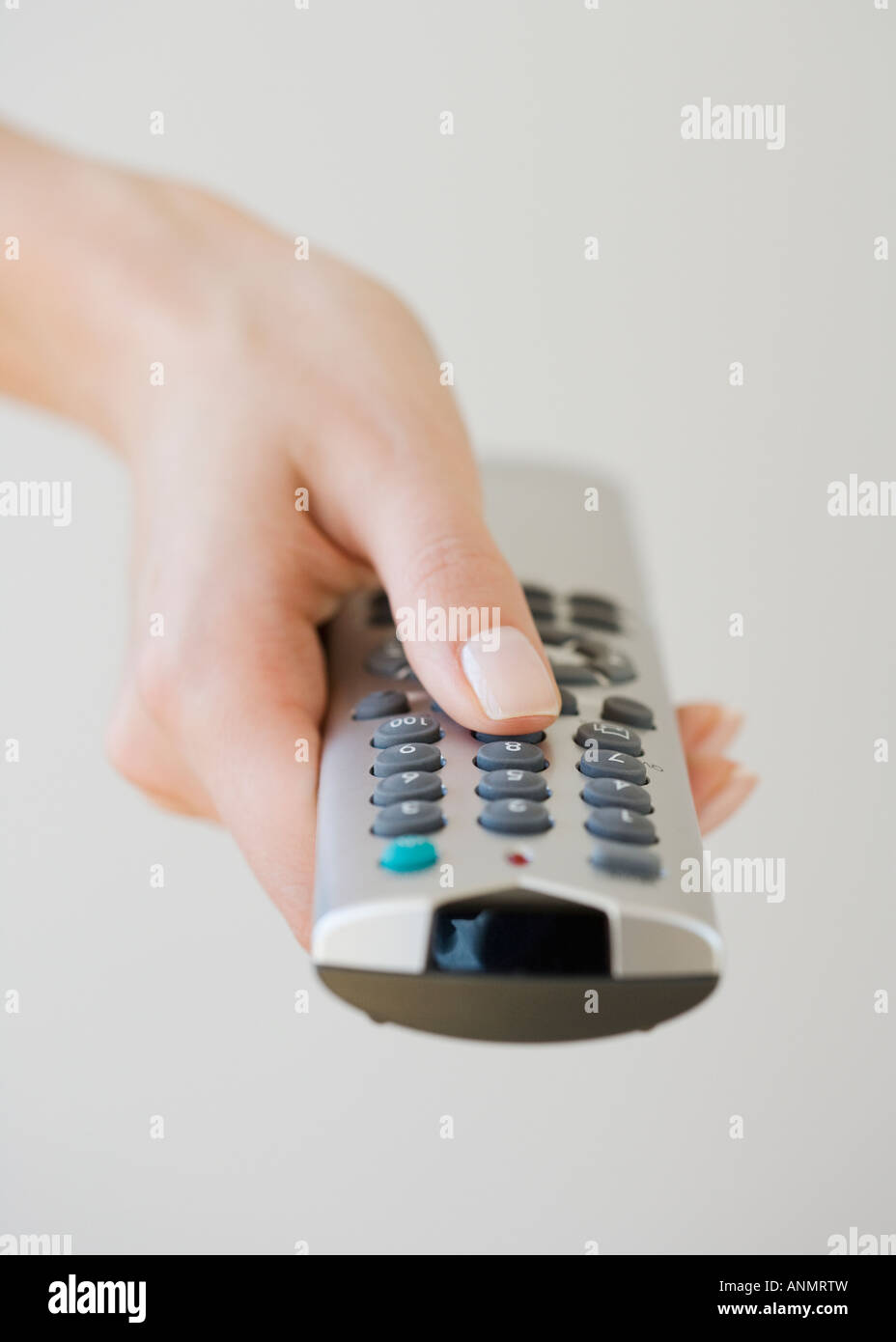 Woman pointing remote control Stock Photo - Alamy