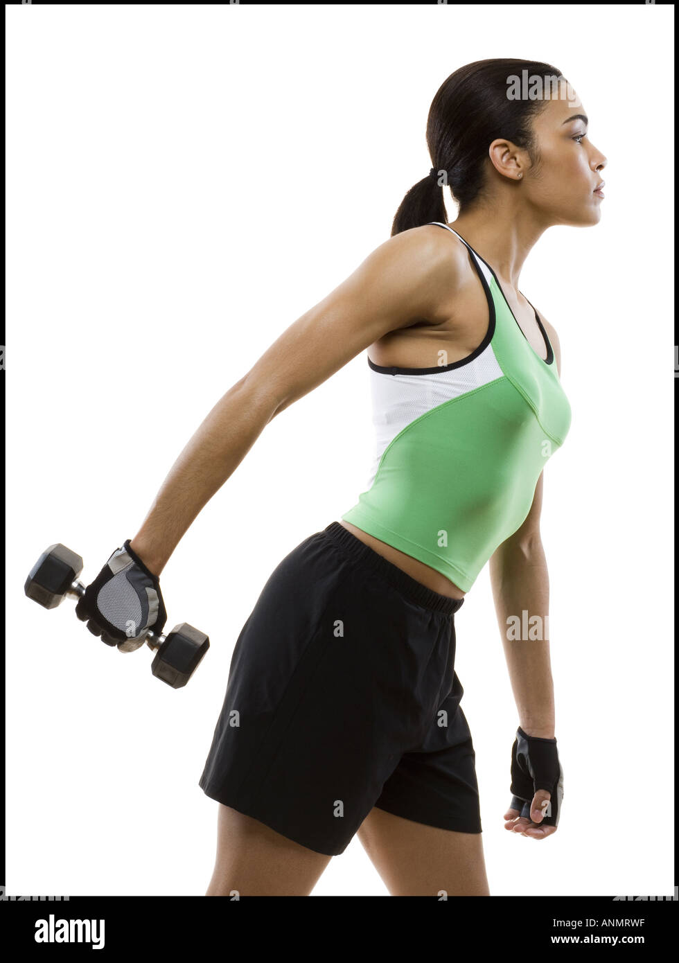 Profile of a young woman exercising with a dumbbell Stock Photo - Alamy