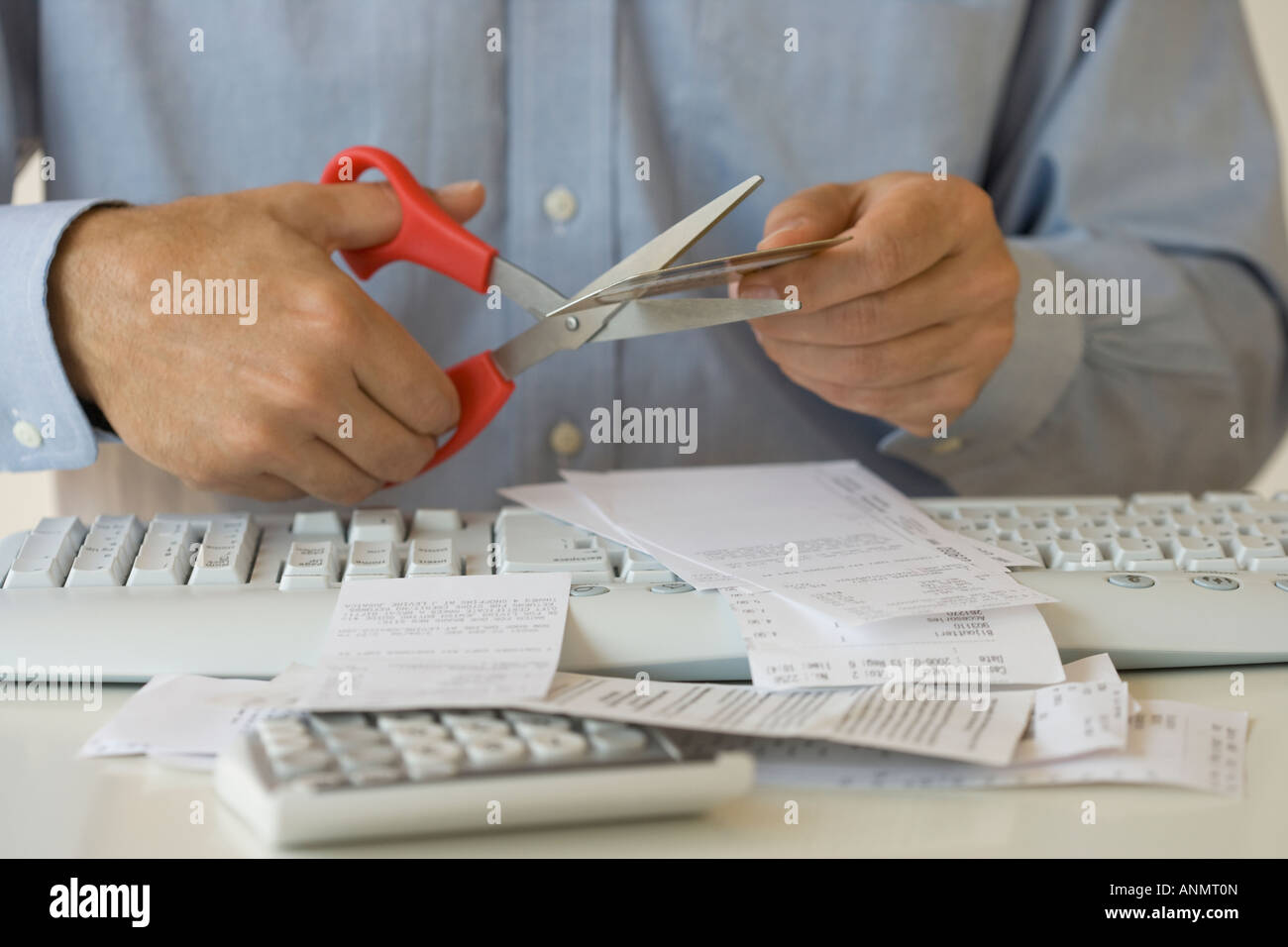 Man cutting up credit card Stock Photo - Alamy