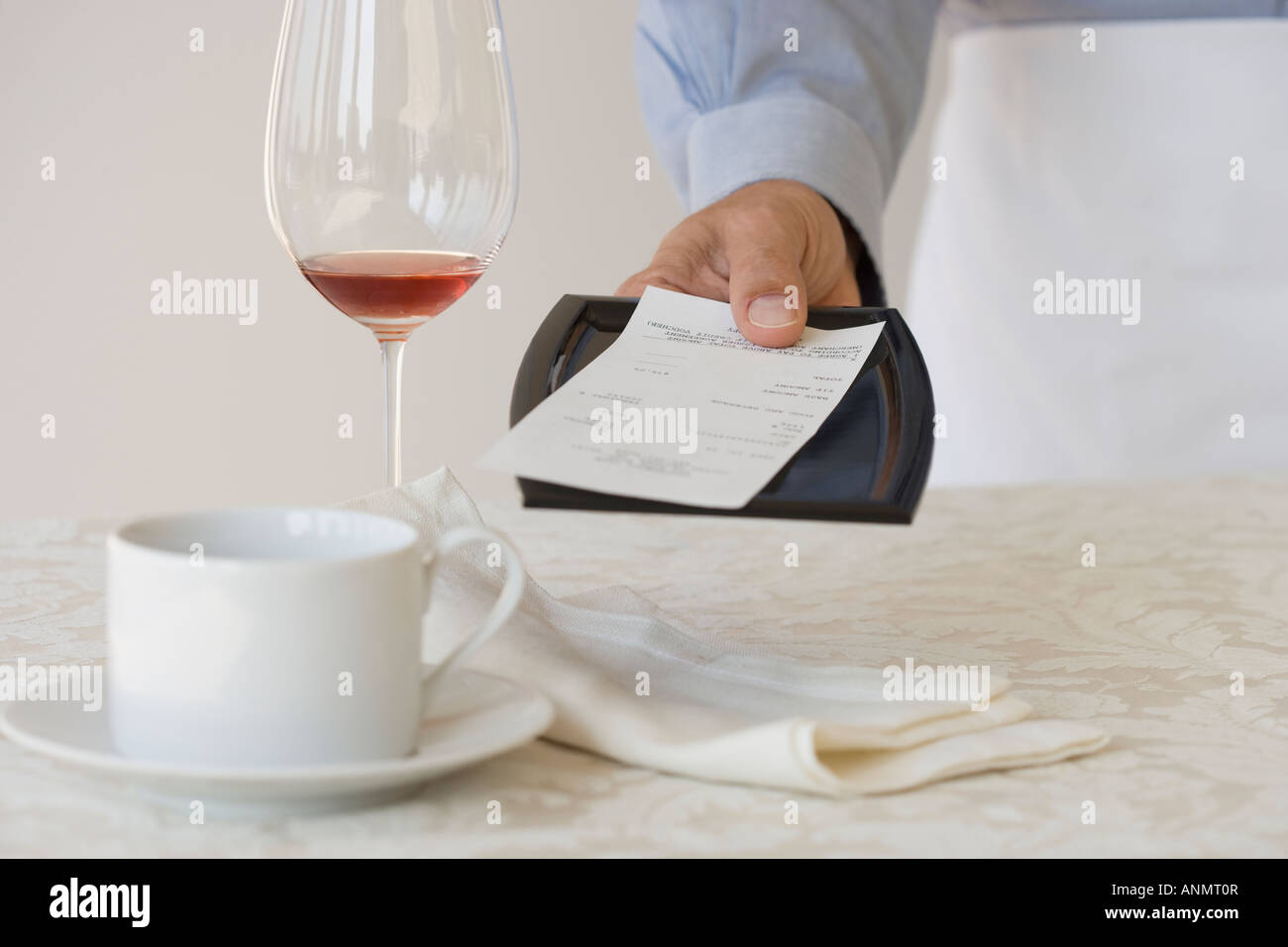 Waiter leaving check on table Stock Photo - Alamy