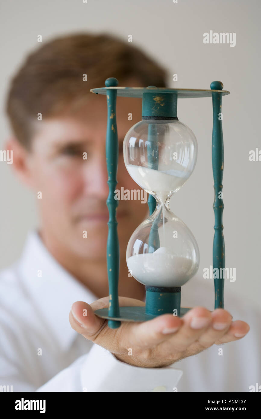 Man holding hourglass Stock Photo - Alamy Man holding hourglass Stock Photo - Alamy