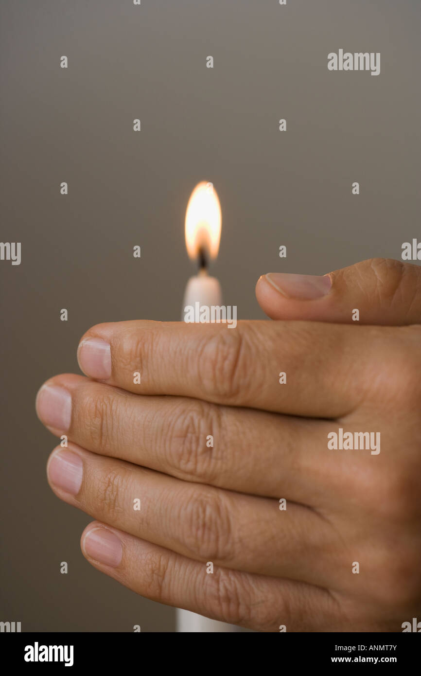 Hand holding candle hi-res stock photography and images - Alamy