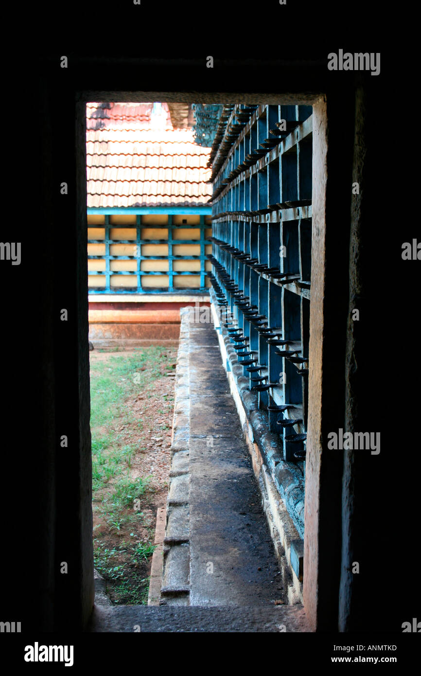 A rectangular opening in a black door through which is seen rows of ...