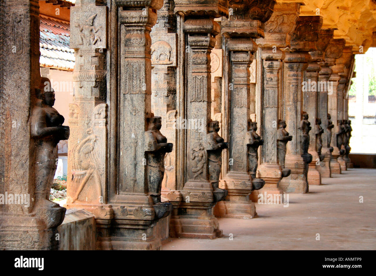 Close up of the stone pillars with sculptures lining the side of a long ...