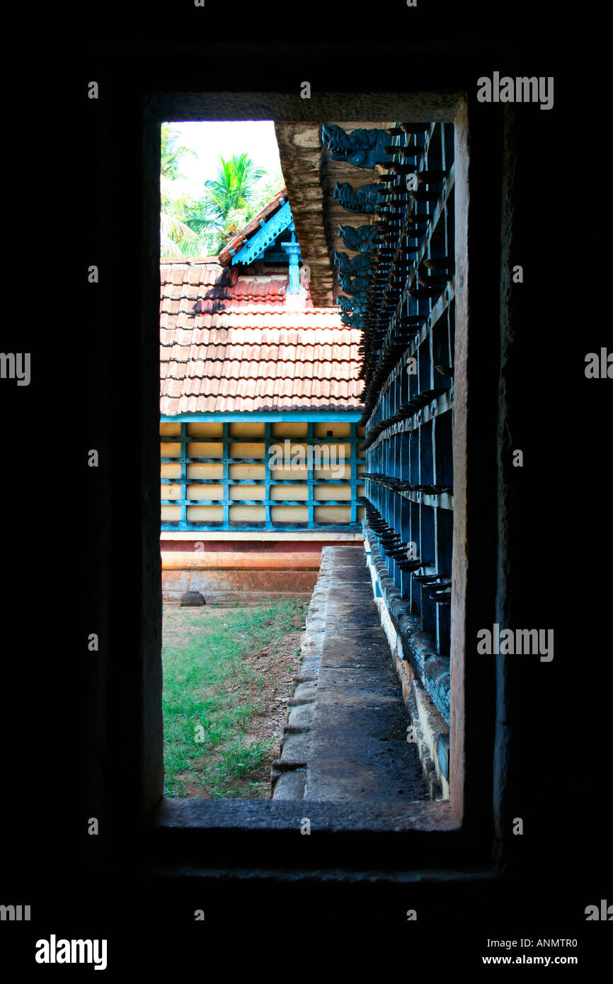 A rectangular opening in a black door through which is seen rows of ...