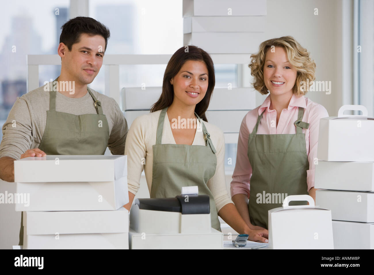 Multi-ethnic bakery workers behind counter Stock Photo - Alamy