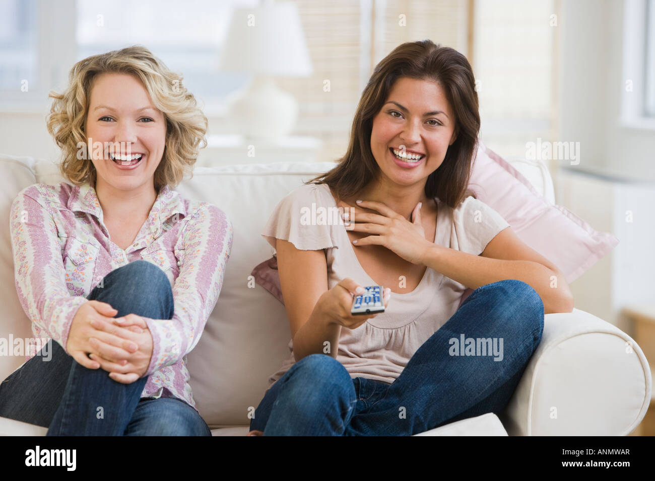 Multi-ethnic women watching television Stock Photo - Alamy