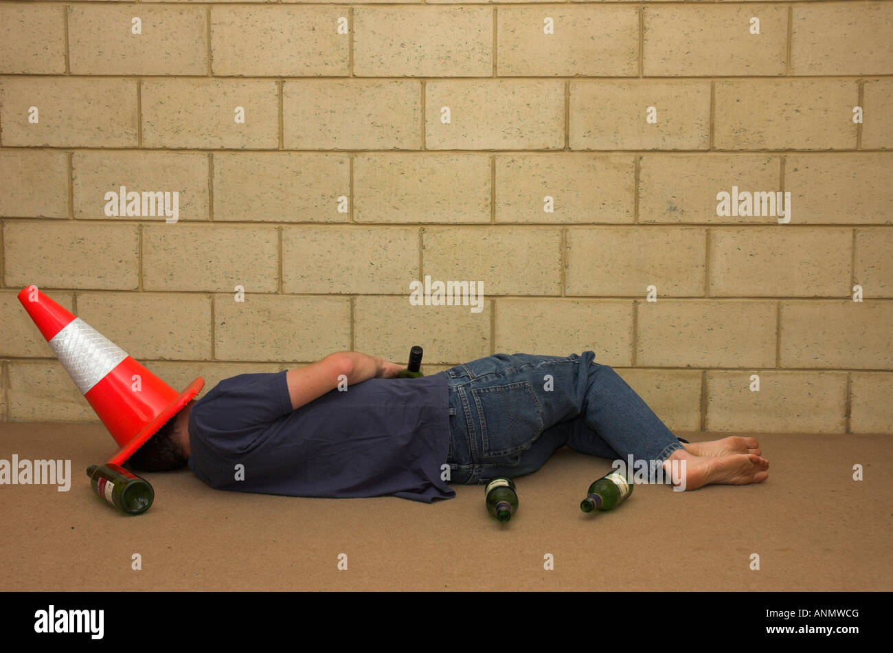 Drunken student passed out with empty bottles and traffic cone Stock ...
