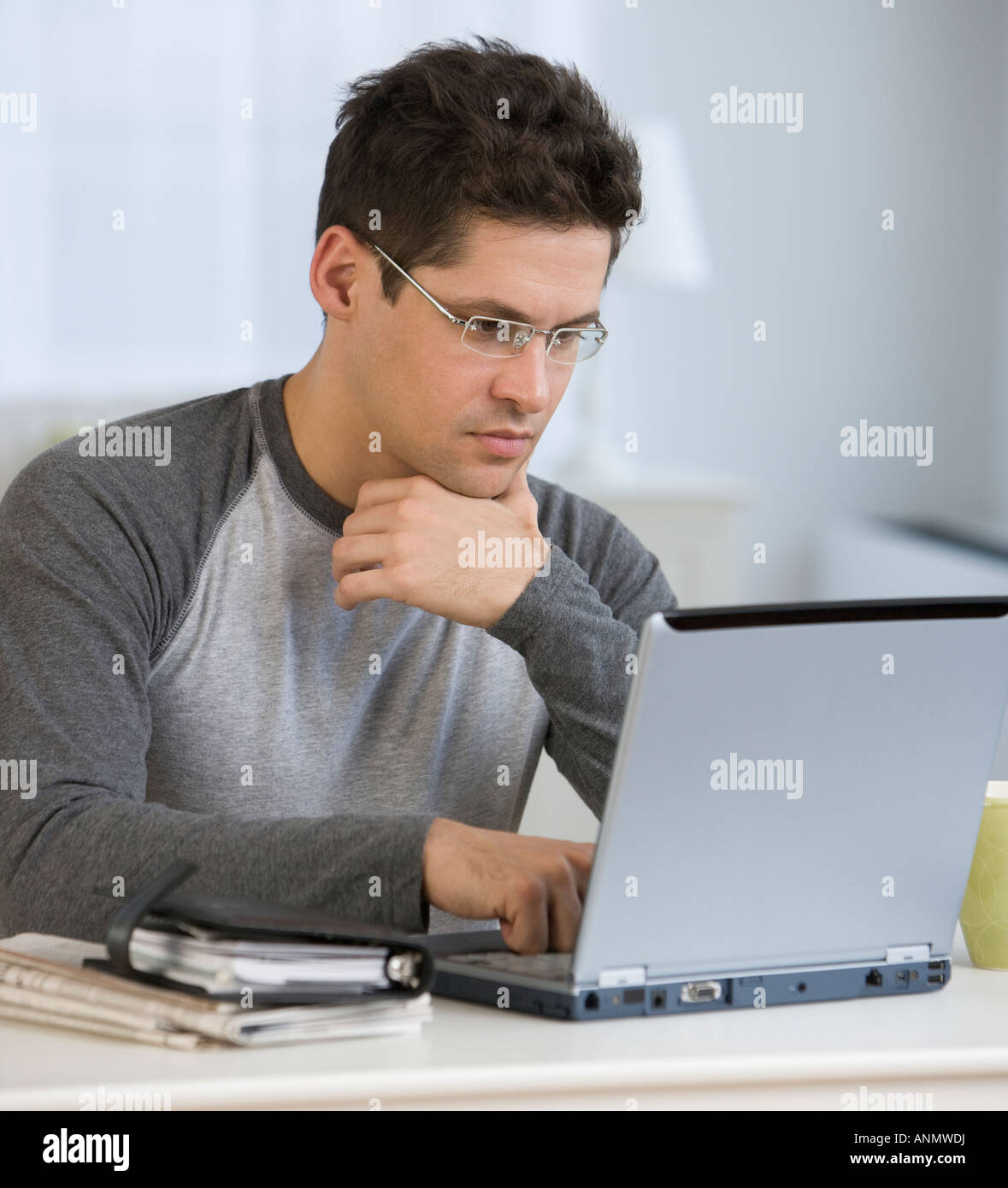 Man looking at laptop Stock Photo - Alamy