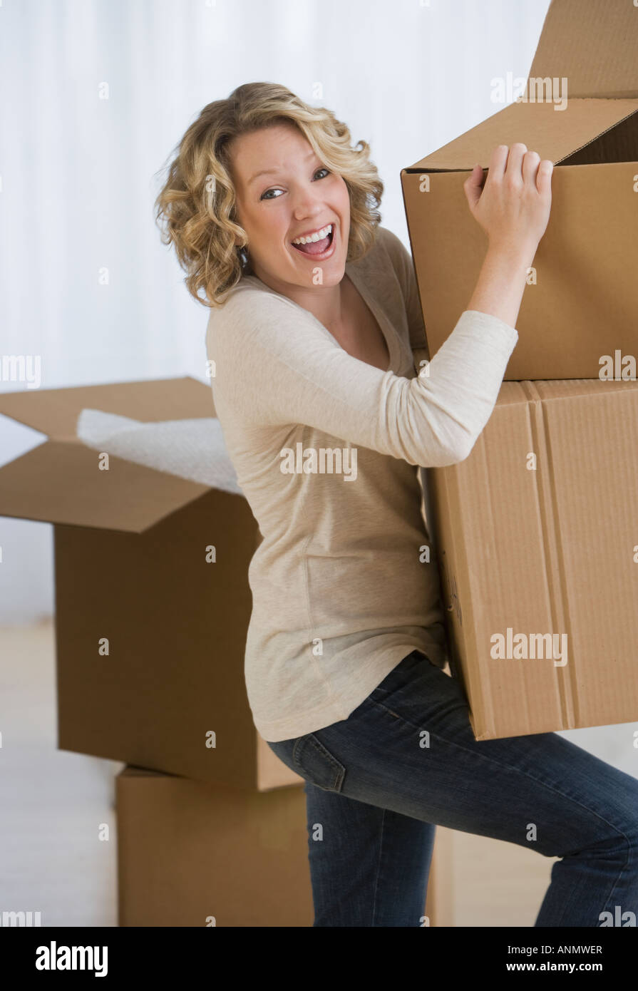 Woman carrying moving boxes Stock Photo - Alamy