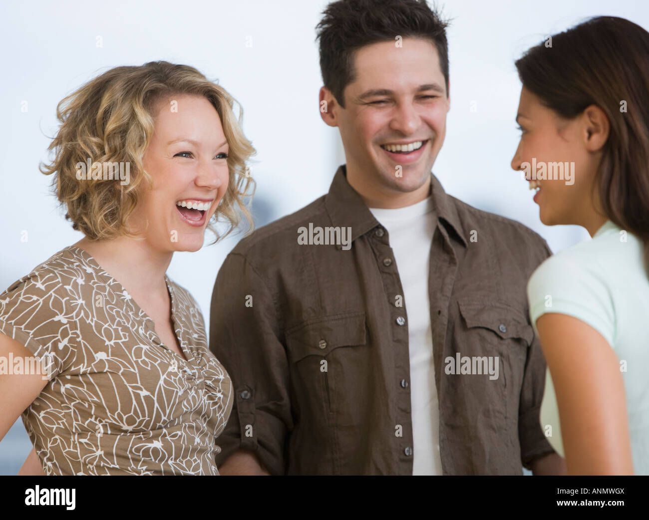 Multi-ethnic friends laughing Stock Photo - Alamy