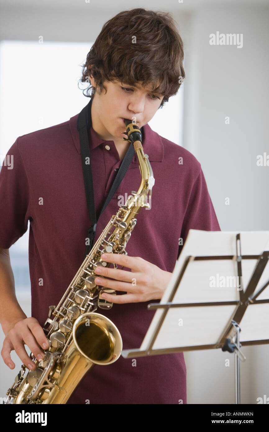 Boy playing saxophone hi-res stock photography and images - Alamy