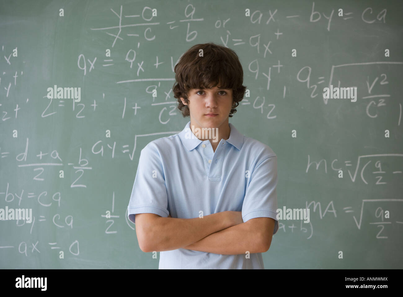 Teenaged boy in front of blackboard with math equations Stock Photo - Alamy