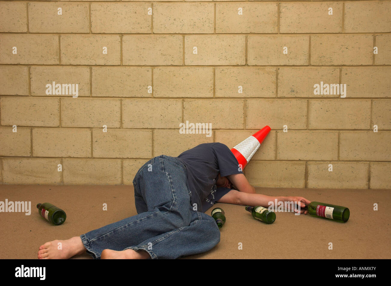 Drunken student passed out with empty bottles and traffic cone Stock ...