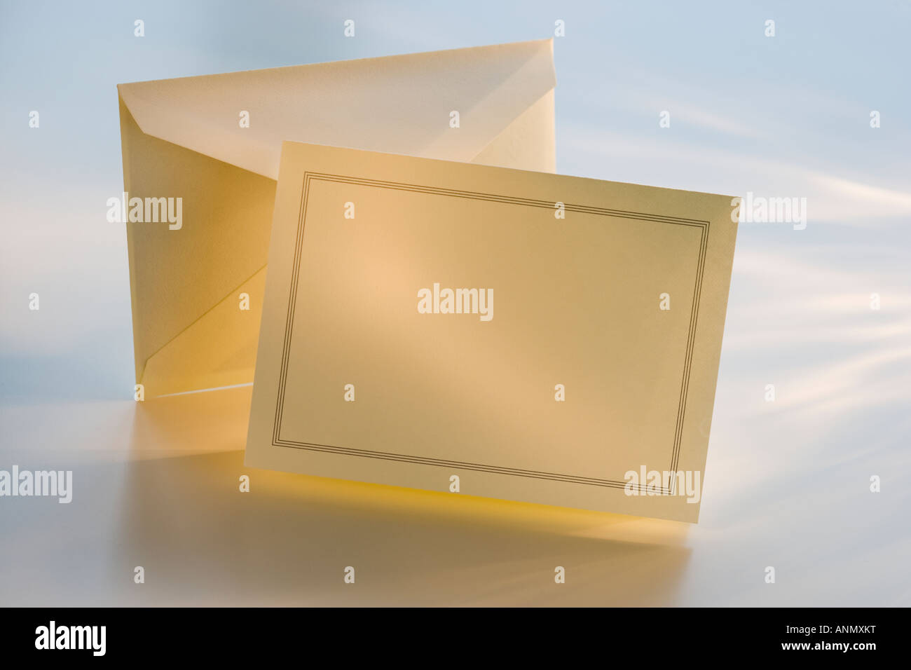 Blank invitation and envelope on table Stock Photo - Alamy