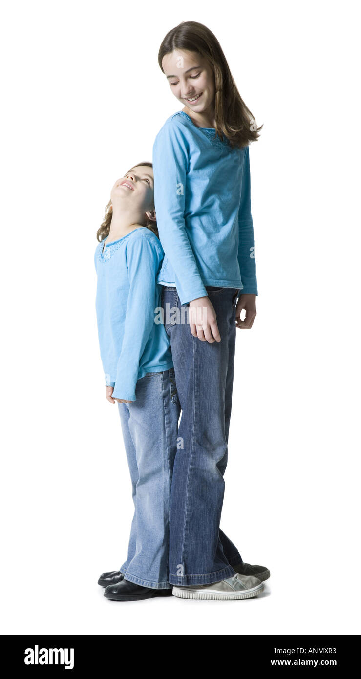 Side profile of two girls standing back to back Stock Photo - Alamy