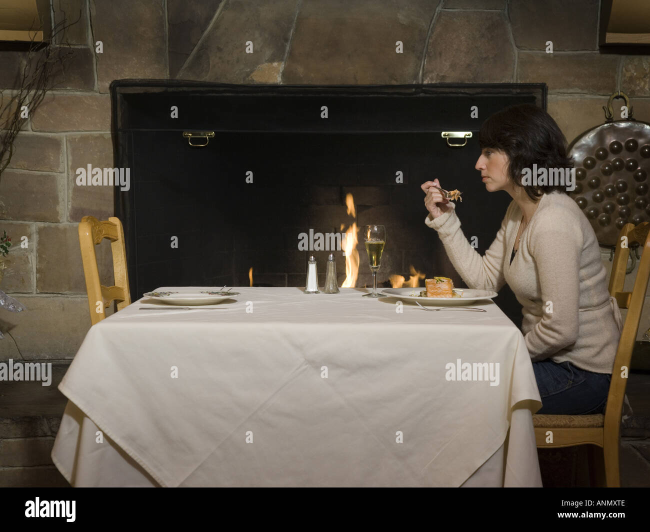 Profile of a mid adult woman eating food Stock Photo - Alamy