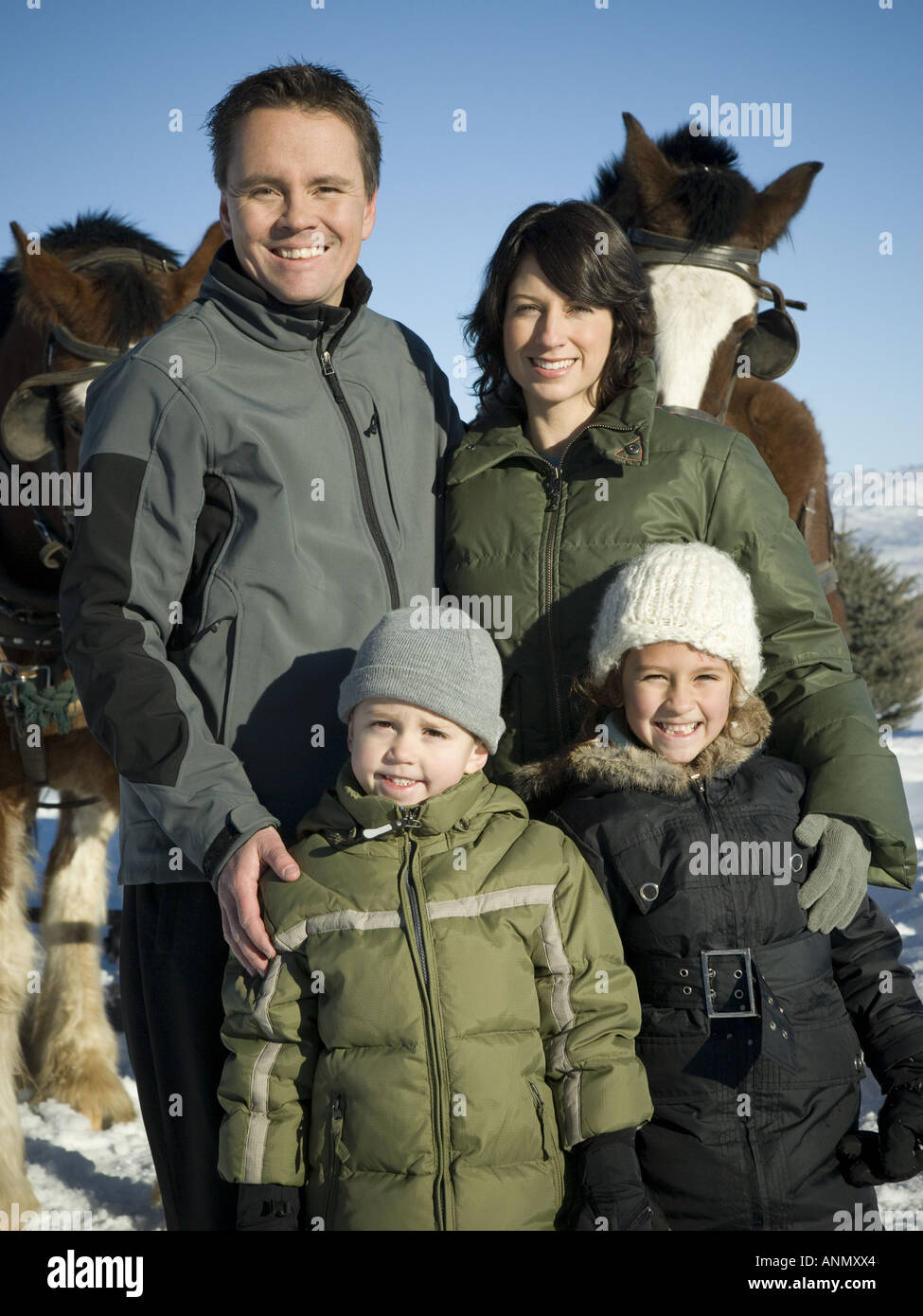 Portrait of parents standing with their two children Stock Photo - Alamy