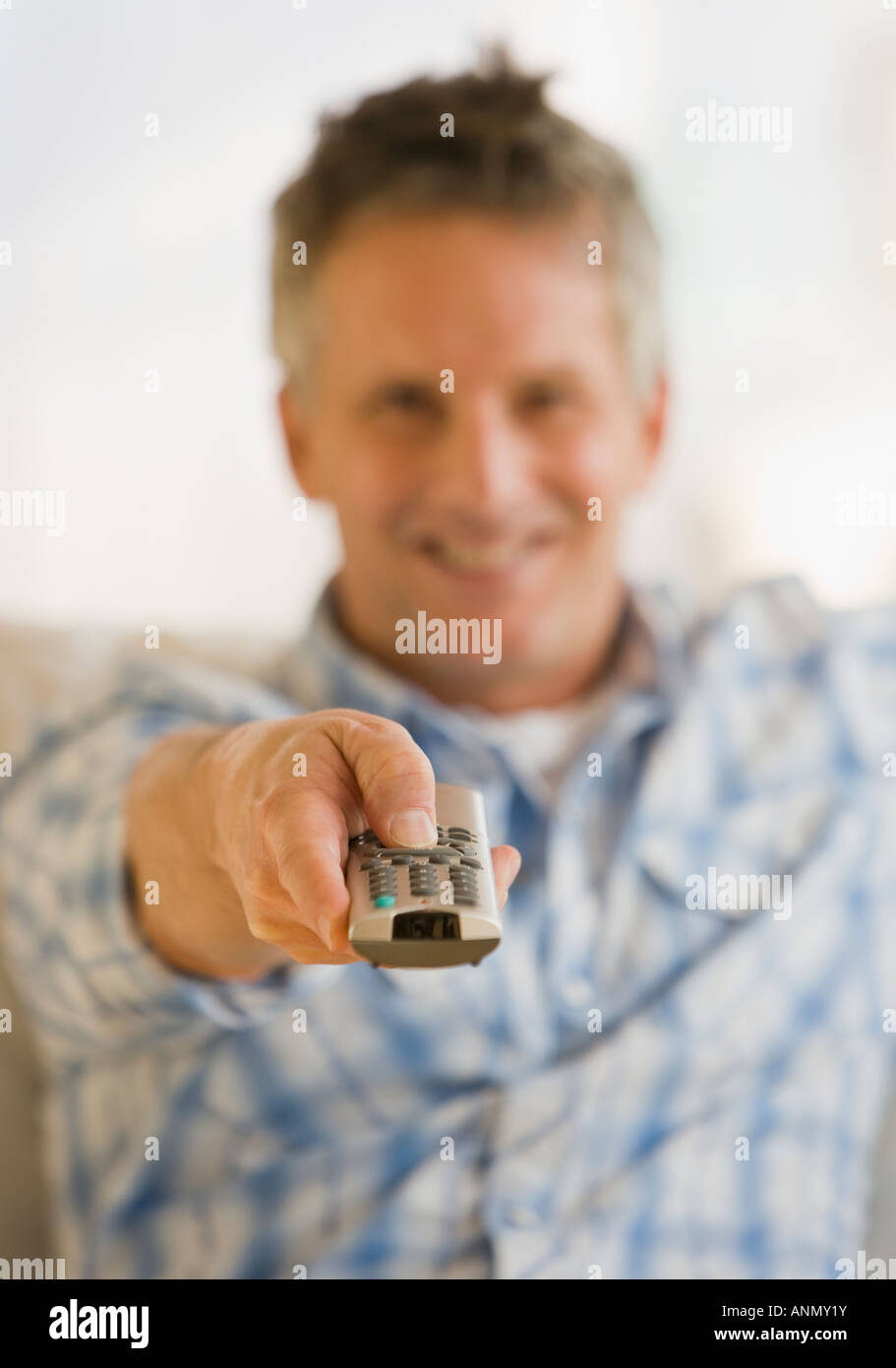 Man pointing television remote control Stock Photo - Alamy