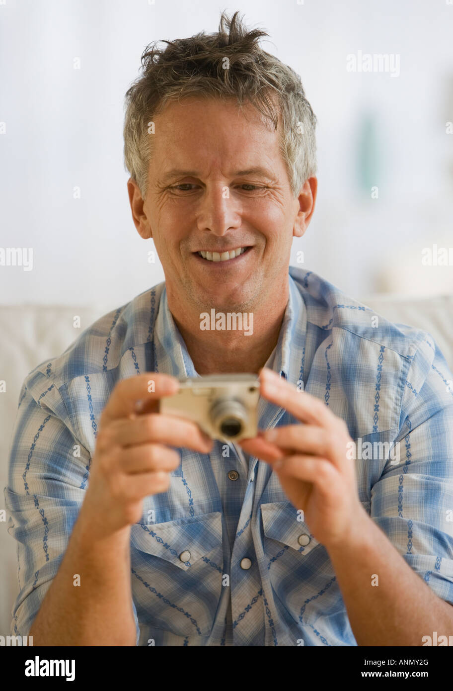 Man looking at digital camera Stock Photo - Alamy