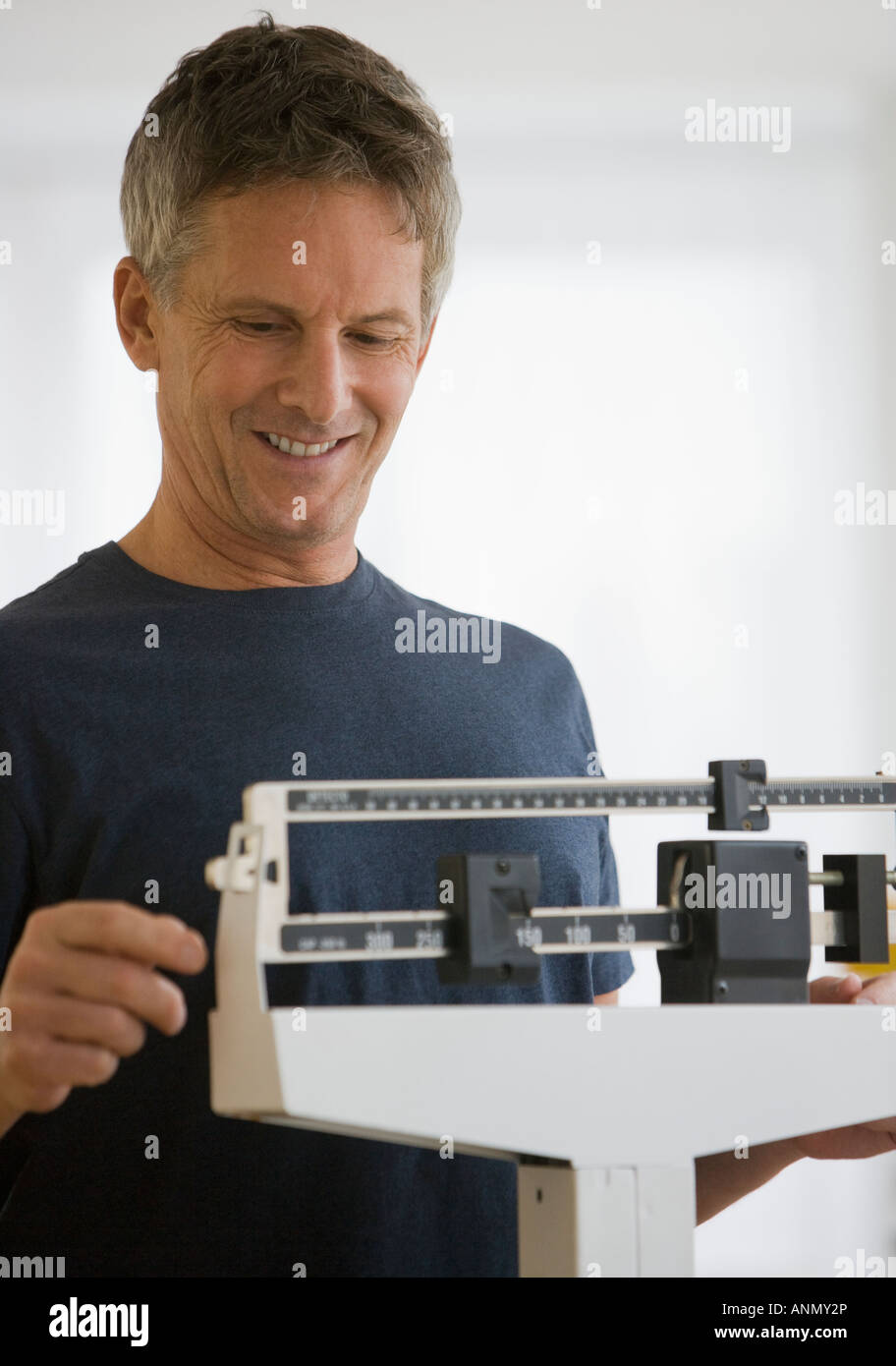 Man standing on scale Stock Photo - Alamy